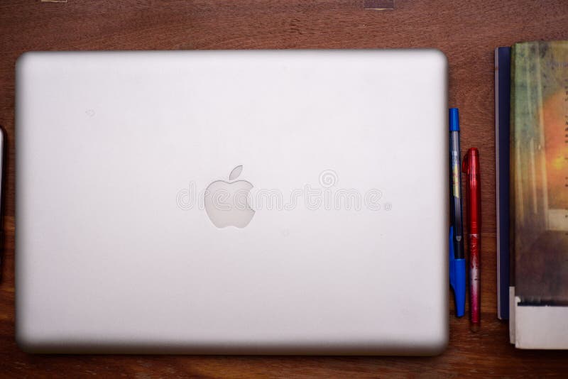 Book, Macbook and a Pen on Wooden Table Editorial Photo - Image of ...