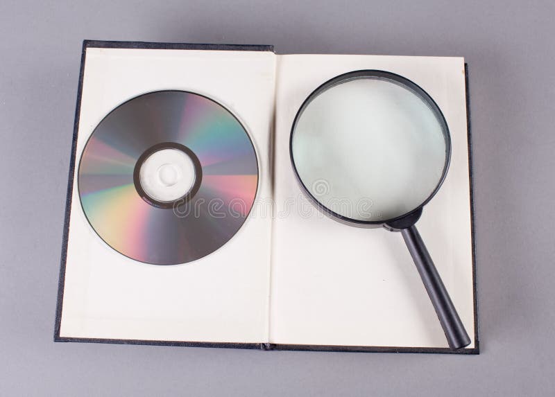Book with Magnifying Glass, Compact Disk on Grey Stock Image - Image of ...