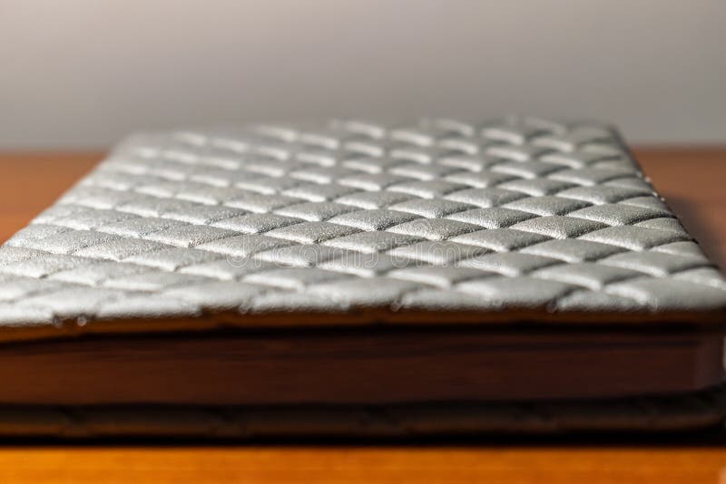 A Book, a Notebook with a Checkered Pattern on a Wooden Table in ...