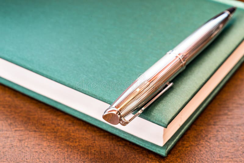 Book with a Pen on the Table Stock Photo - Image of hand, business ...