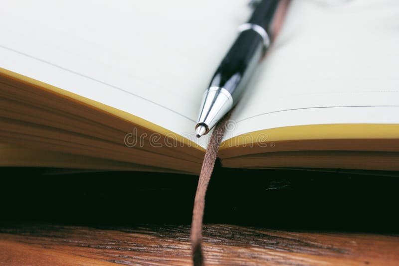 Book with a Pen on a Wooden Table Editorial Stock Image - Image of ...