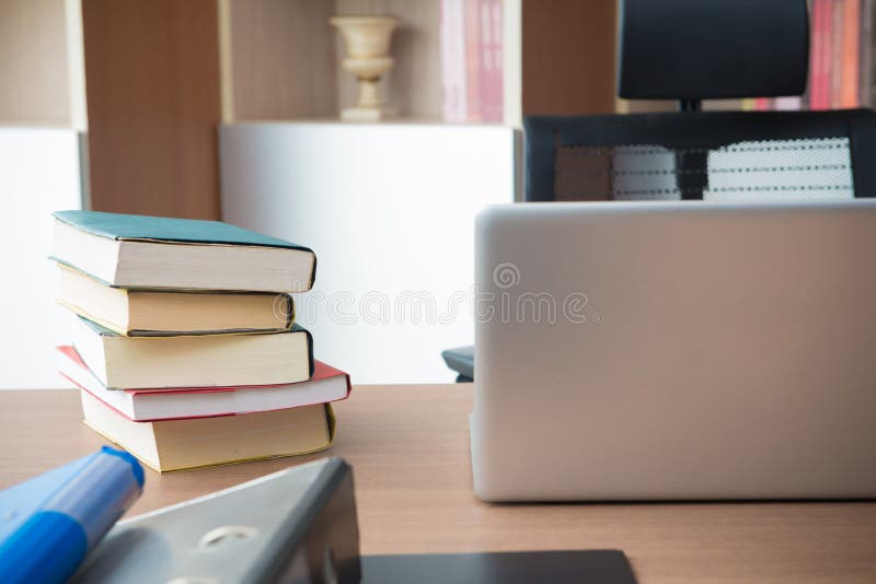 Book Stack and Laptop on Table in Office Stock Image - Image of ...