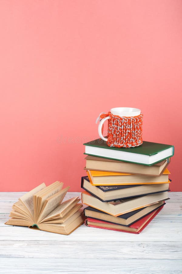 Book Stacking. Open Book, Hardback Books On Wooden Table And Pink ... Book Stacking. Open Book, Hardback Books On Wooden Table And Pink ...