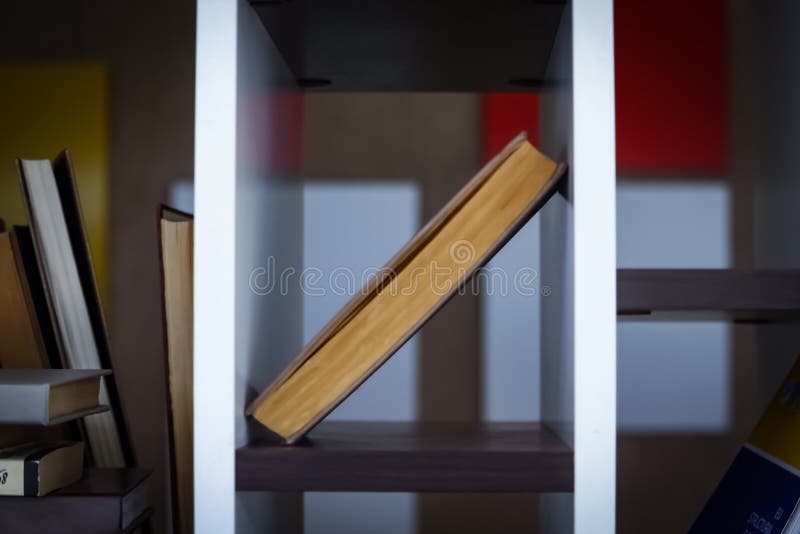 Book Standing in Diagonal on Shelf on Dark Blurred Background Stock ...