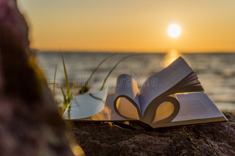 Book on a Stone with Sun Setting on Abckground Stock Image - Image of ...