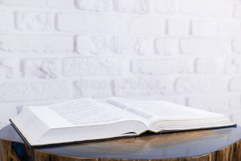The Book is on the Table. Open Holy Bible. Decorative Wooden Table ...