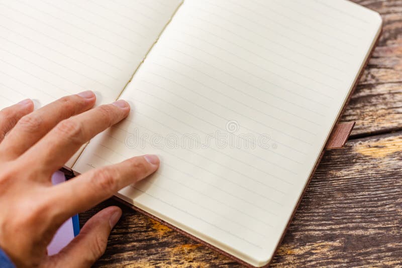 A Book on Wood Table and Open by Man Hand Stock Photo - Image of hand ...