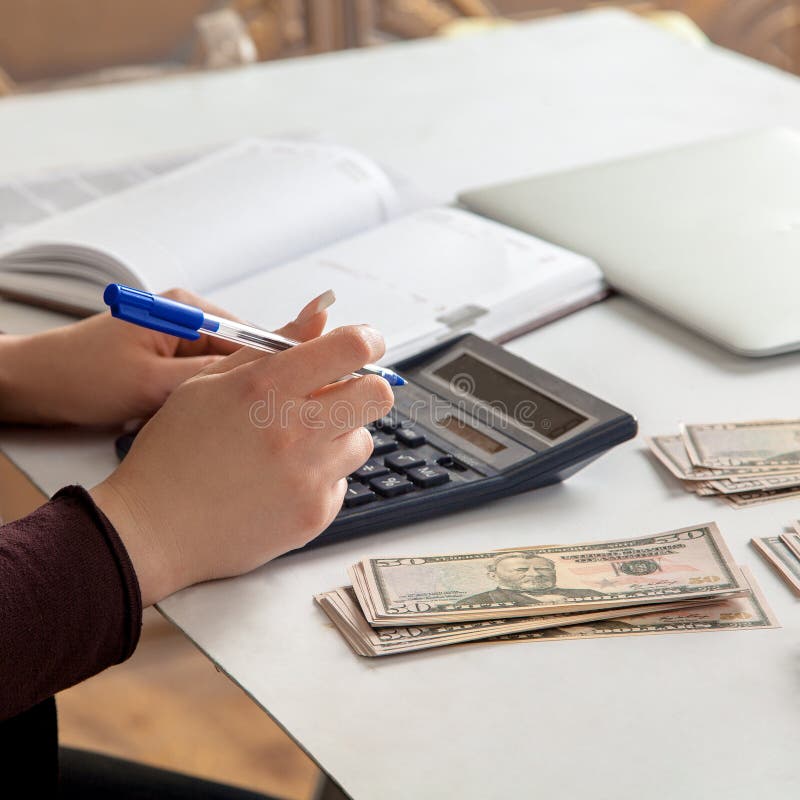 Bookkeeper Counts Money on Calculator at the Table Stock Photo - Image ...