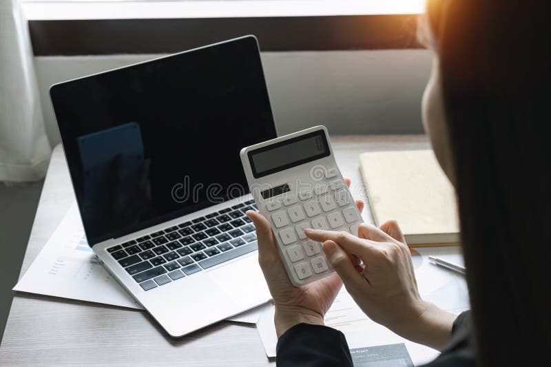 Bookkeeper Using a Calculator To Calculate Numbers on a Company& X27;s ...