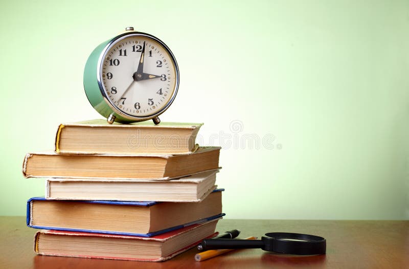 Books and an alarm clock stock image. Image of collection - 30427523