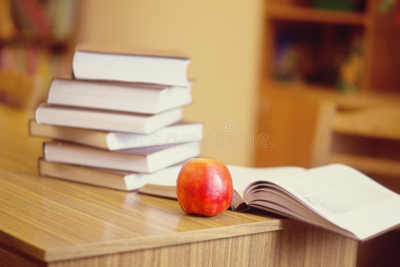 Books and Apple on Blurred Library Background Stock Image - Image of ...