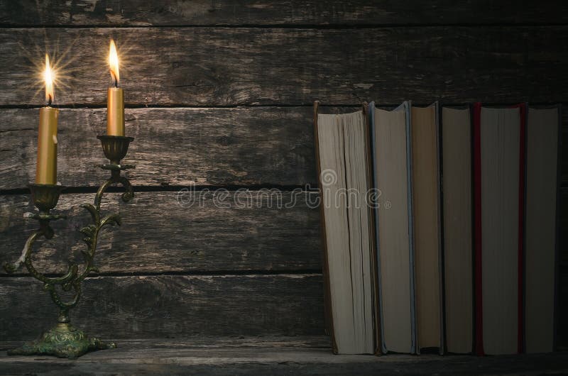 Books and burning candle. stock photo. Image of note - 125277066