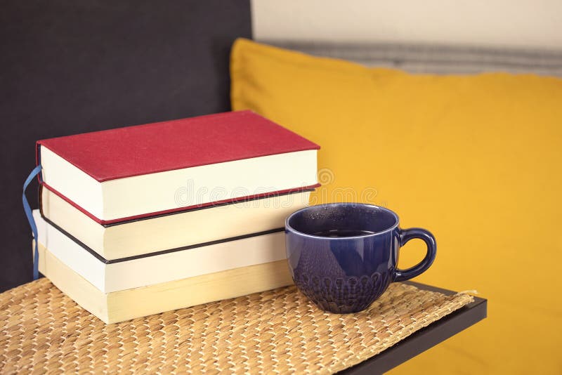 A Lot of Books with Cup of Coffee or Tea on the Table with Cozy Couch ...