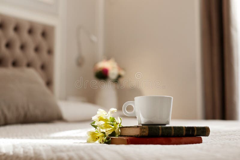 Books, Flowers, and a Coffee Cup Lie on the Bed. Romantic Gift ...