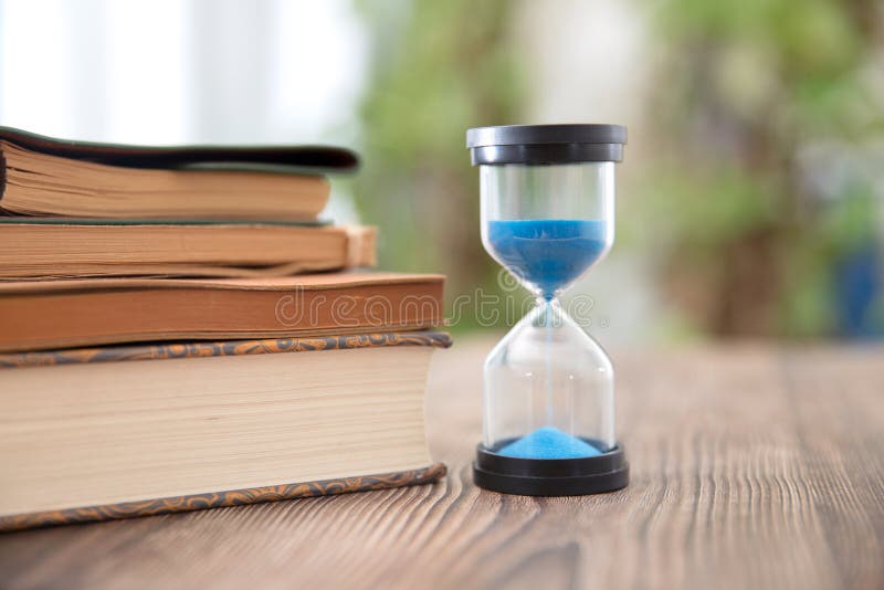 Books and Hour Glass on the Table Stock Image - Image of desk, fine ...
