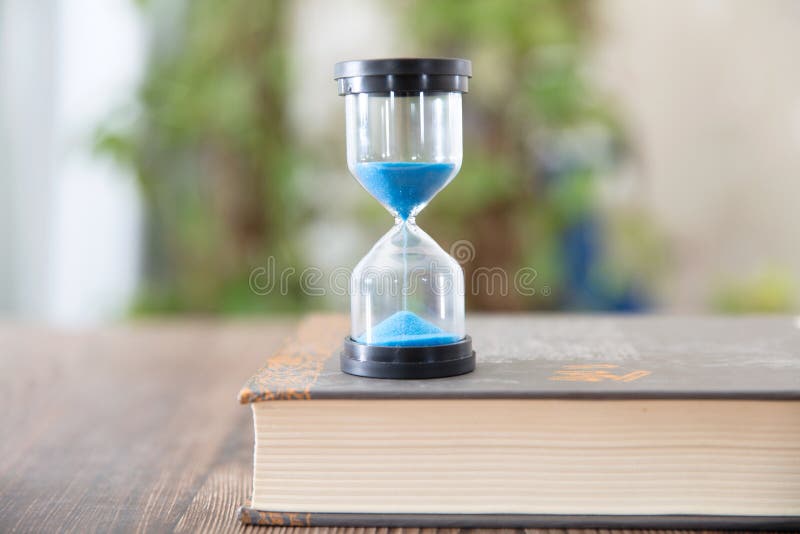 Books and Hour Glass on the Table Stock Photo - Image of stack, culture ...