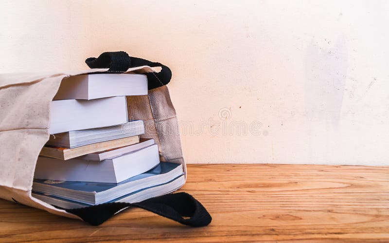 Books Inside Cloth Bag on Wood Table Stock Image - Image of space ...