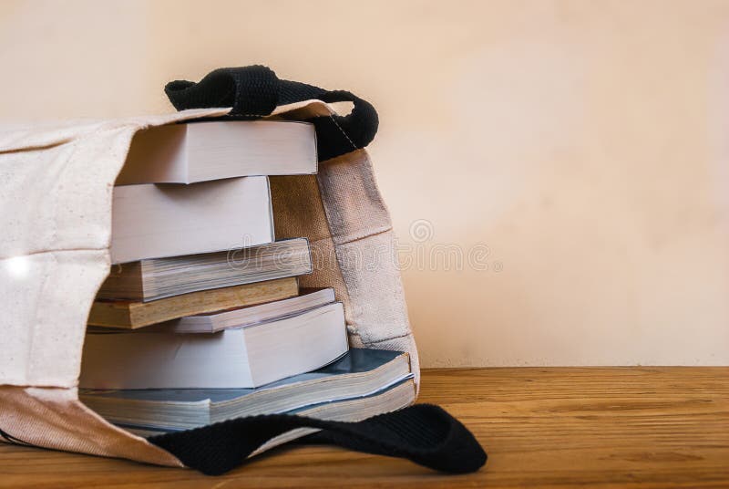 Books Inside Cloth Bag on Wood Table Stock Image - Image of style ...