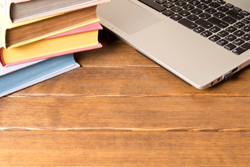 Books and Laptop on Wooden Table. the Concept of Learning from Books or ...