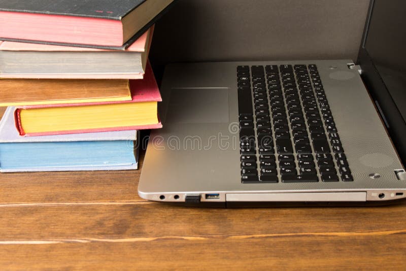 Books and Laptop on Wooden Table. the Concept of Learning from Books or ...