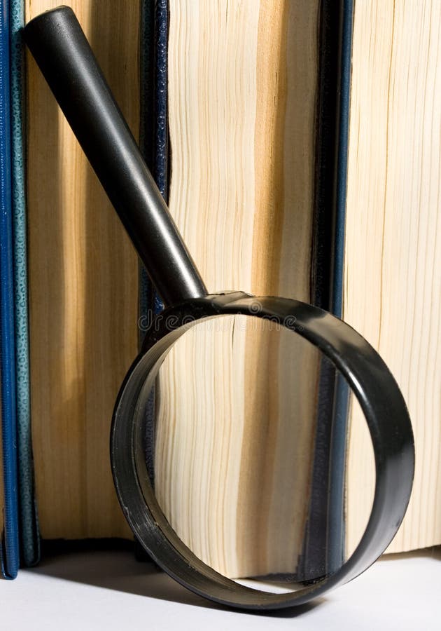 Books and magnifying glass stock image. Image of notebook - 32681689
