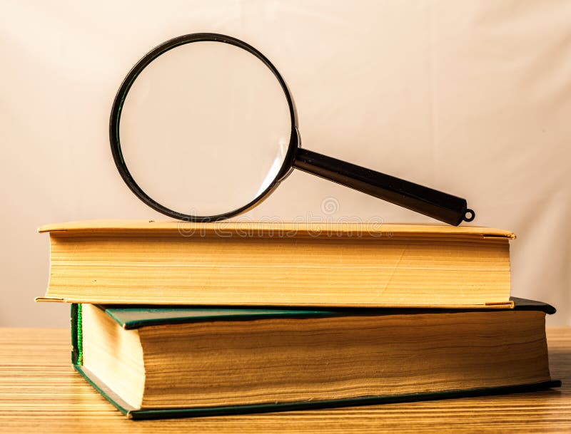Books and magnifying glass stock photo. Image of school - 77806456