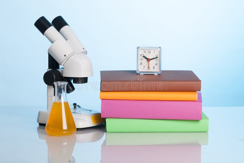 Books and a Microscope on the Desk of the Student Stock Photo - Image ...