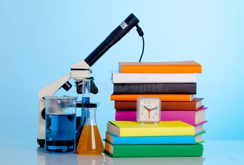 Books and a Microscope on the Desk of the Student Stock Image - Image ...