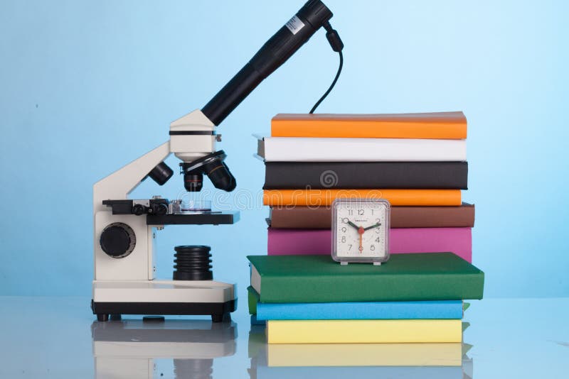 Books and a Microscope on the Desk of the Student Stock Photo - Image ...