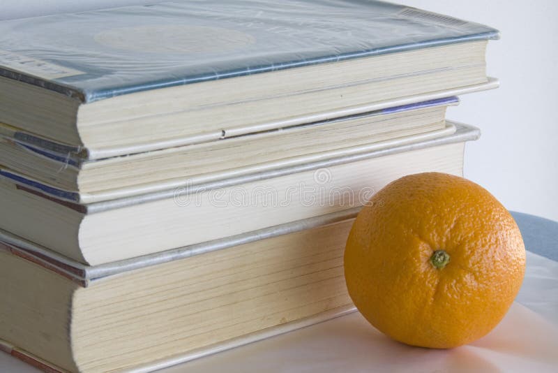 Books and an orange. stock photo. Image of fruit, food - 13375410