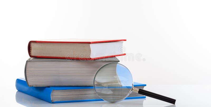 Books Stack and Magnifying Glass on White Background Stock Photo ...
