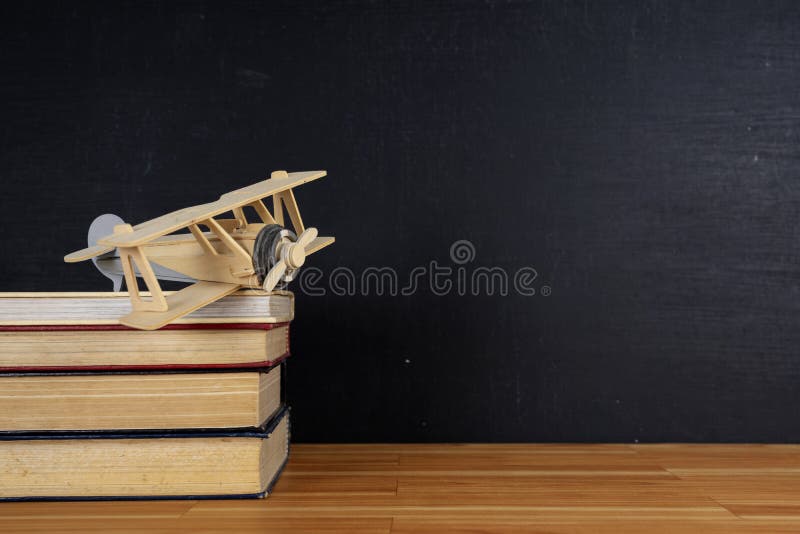 The Books that are Stacked and Plane Model Placed on the Table Stock ...