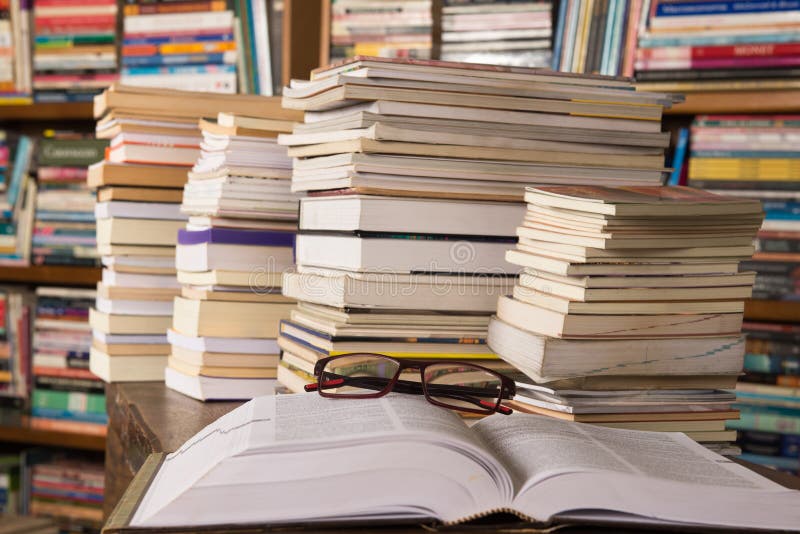 Books on the Table and in Bookshelves in the Background Stock Image ...