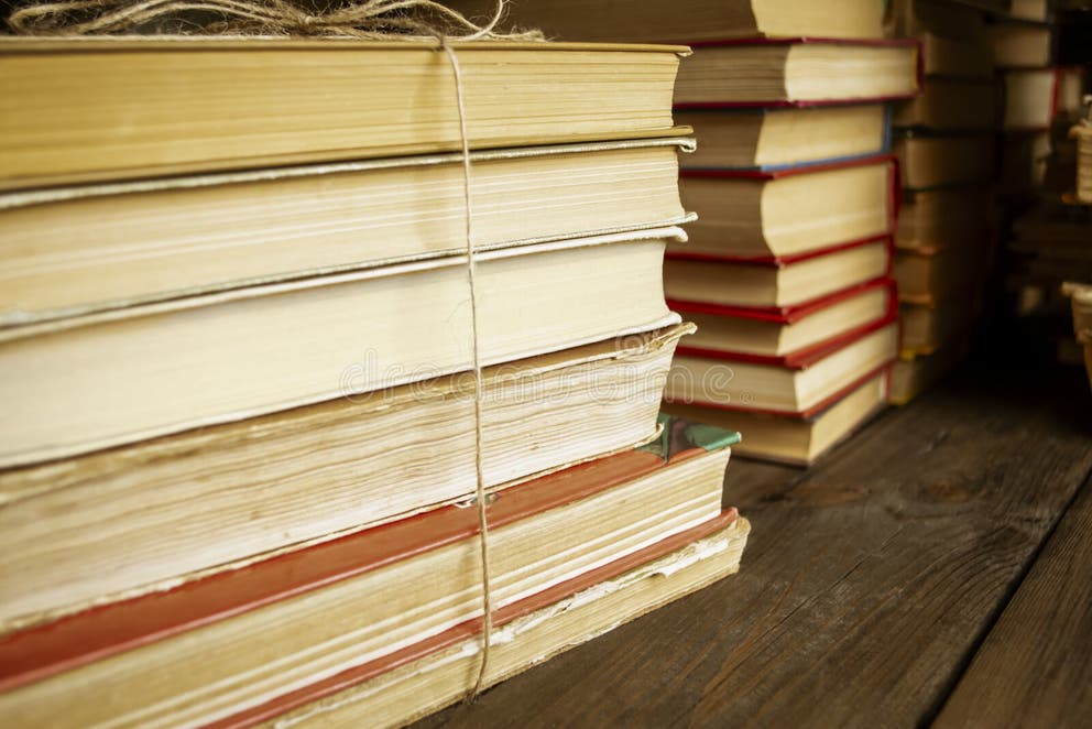 Books Tied with String Stand on a Wooden Table. Several Books are Put ...