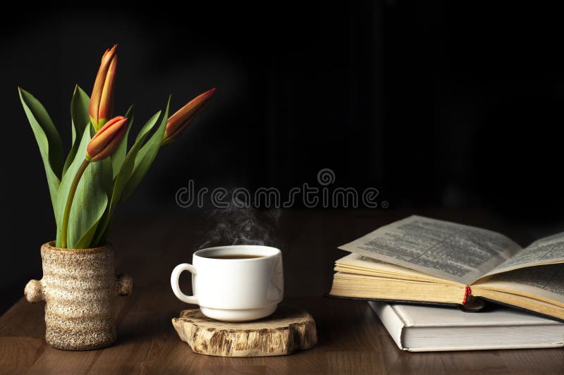 Books on a Wooden Table. a Cup of Coffee. Flowers on the Book. a Stack ...