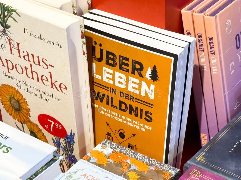 Bookshelf with Assorted Books in German Focusing on Survival and ...