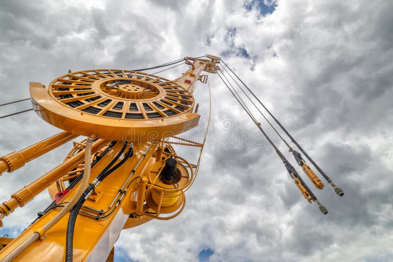 The Boom of a Drilling Machine and a Crane Against the Sky. Stock Image ...