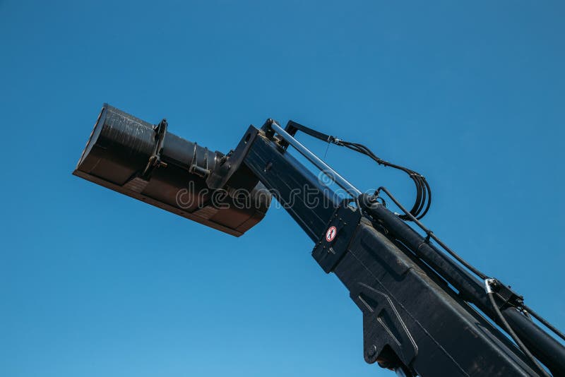 Boom of the Excavator with Bucket on Blue Sky Background Stock Photo ...