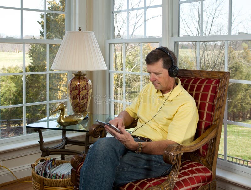 Boomer Reading on Tablet Computer Stock Photo - Image of person ...