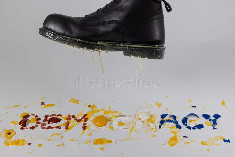 A Boot Crushes the Word Democracy Spelled Out with Eggs Stock Image ...