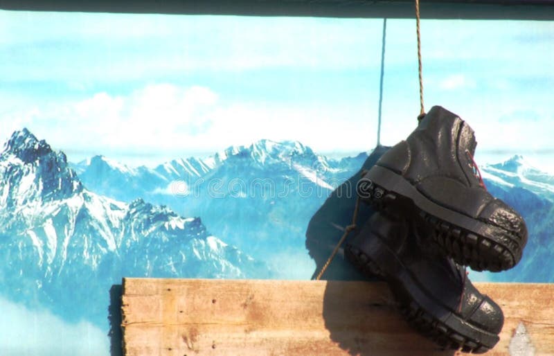 Boots-hanging-on-sports-shop-signboard Picture. Image: 87852394