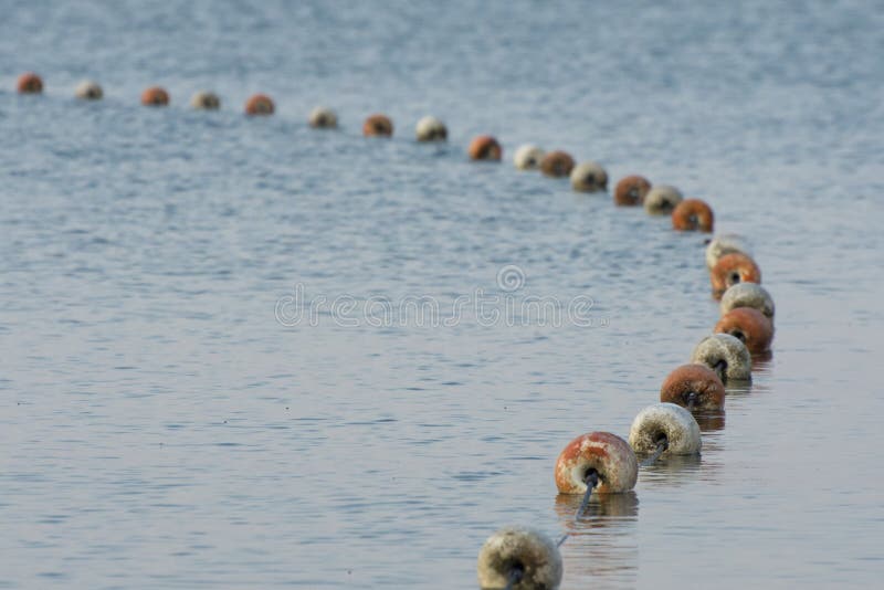 A Border of Old Buoys at Sea. Safety Barrier in the Sea Stock Image ...