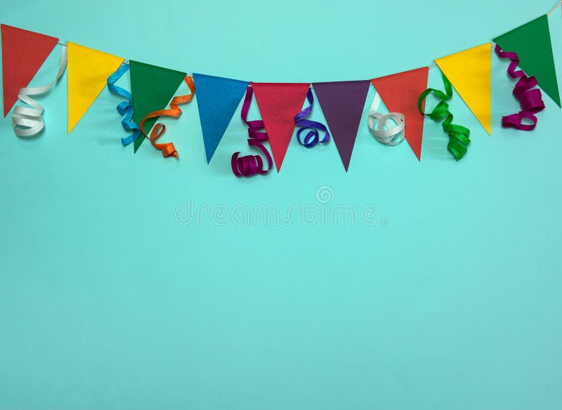 Border of Triangular Colored Paper Flags and Streamers on a Light Blue ...