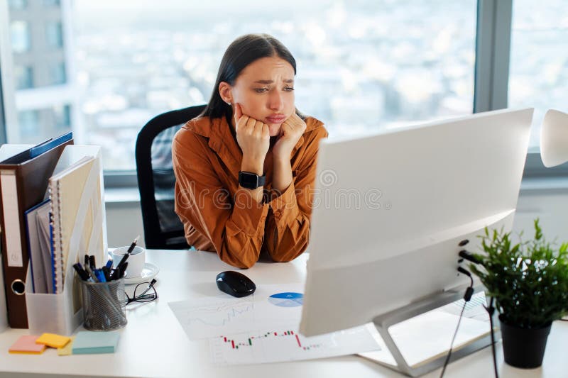 Bored Businesswoman Looking at Computer Screen, Sitting in Office ...