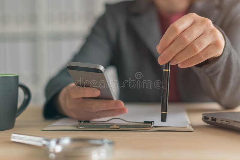 Bored Businesswoman Using Mobile Phone at Work Stock Image - Image of ...