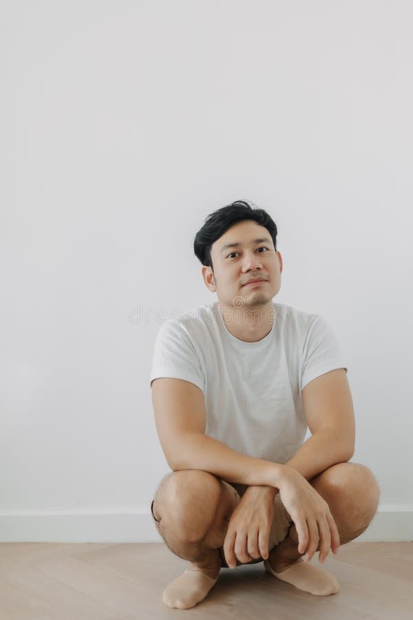 Bored Face Asian Man Squatting on the Floor with White Background Stock Image - Image of ...