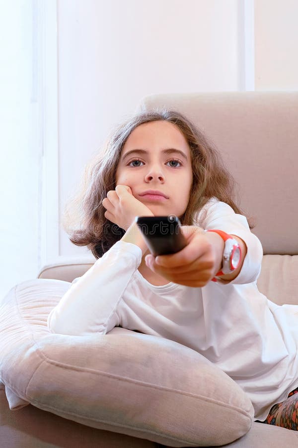 A Bored Girl Flips through TV Channels Stock Photo - Image of downtime, chill: 331962144