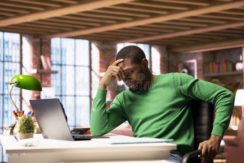 Bored Man Frustrated by Long Wait Time while Using Software on Notebook ...