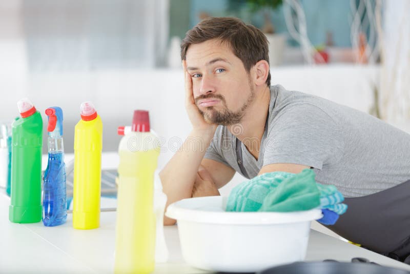 Bored man having to clean stock image. Image of bored - 258798799
