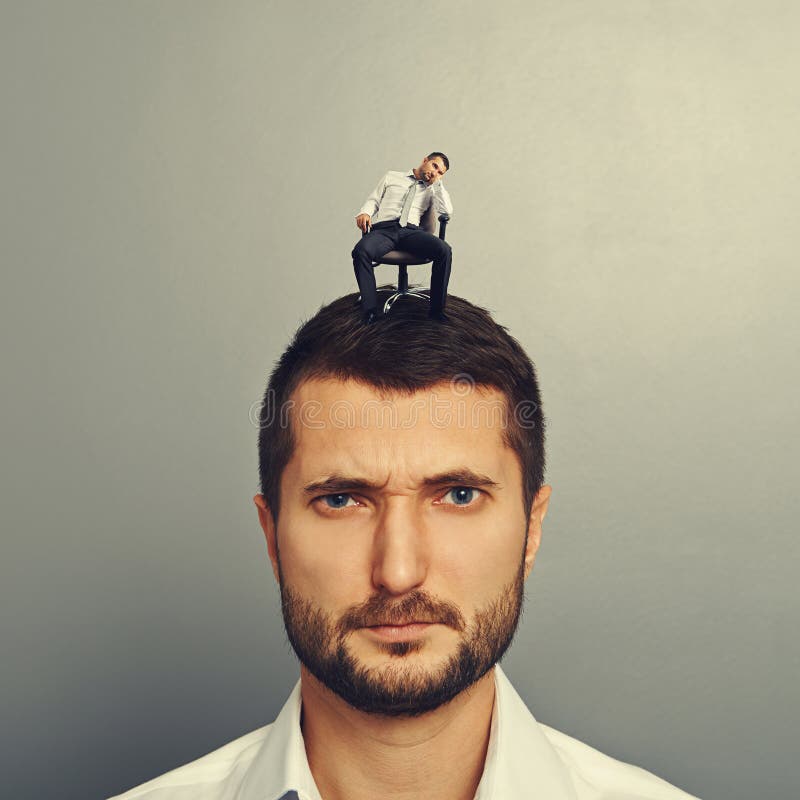 Bored Man Sitting on the Big Head Stock Photo - Image of small, mood ...